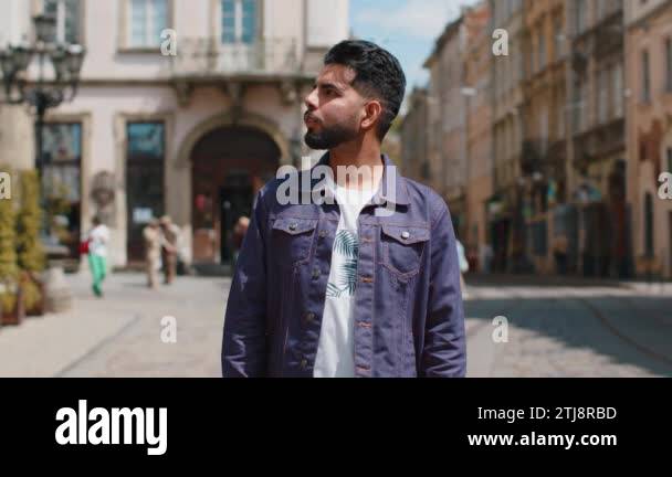 Portrait of indian man tourist walking in urban city street background ...