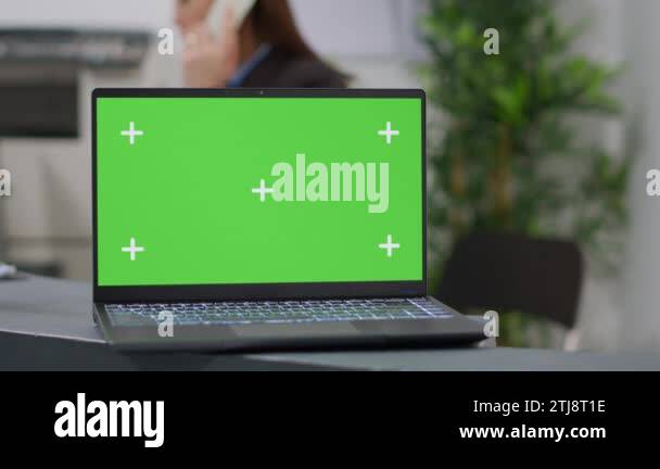 Laptop with greenscreen template at hospital reception desk used by ...