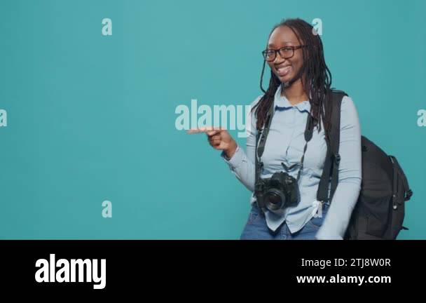 Photographer pointing at left and right side in studio, indicating ...