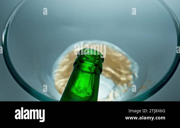 Bottled lager beer pouring vessel closeup. Sparkling cold craft ...