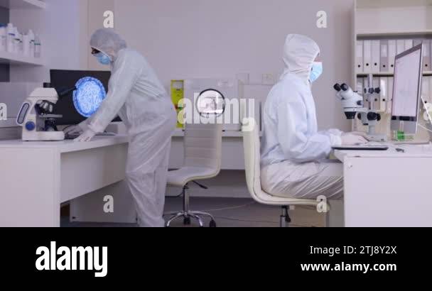 Medical, laboratory staff and safety gear while working on a scientist ...