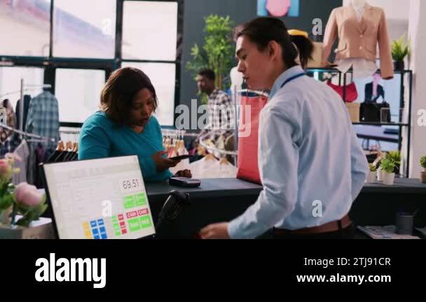 Woman paying with smartphone at pos terminal at counter desk, buying ...