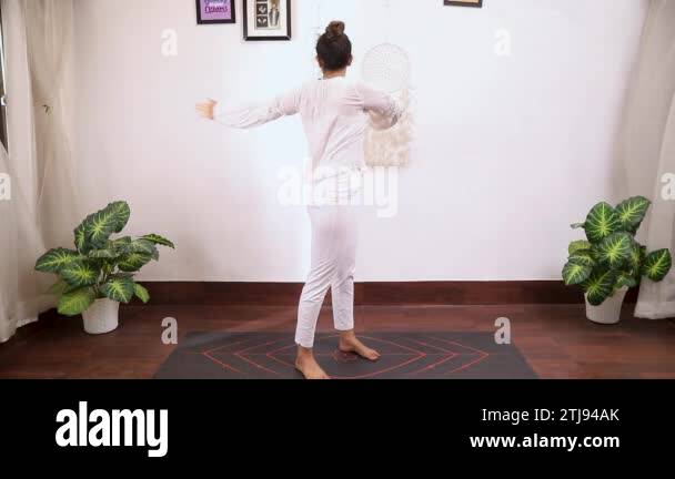 Video of woman performing Katichakrasana (Standing Spinal Twist Pose ... Video of woman performing Katichakrasana (Standing Spinal Twist Pose ...