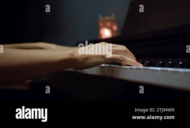 Woman pianist plays gentle classical music on a beautiful grand piano ...