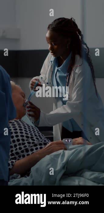 Vertical video: Patient with breathing problems in hospital ward bed ...
