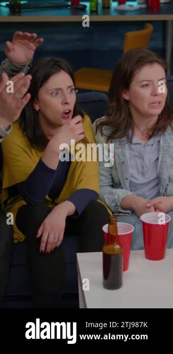 Vertical video: Frustrated group of multiethnic people hanging out ...