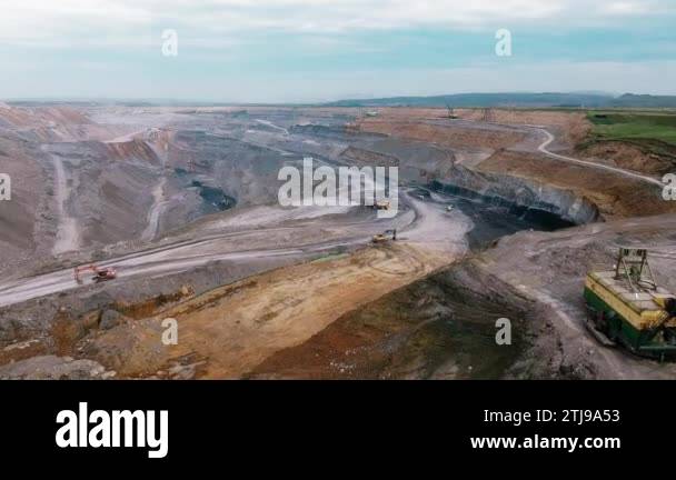 A large quarry from a bird's eye view. Excavators and trucks all over ...