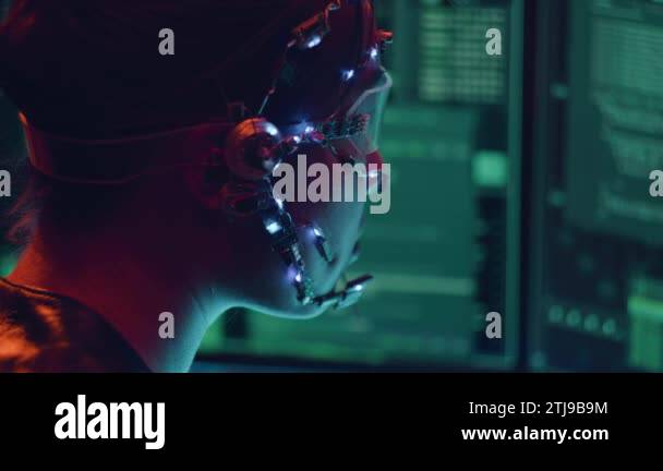 Side view of an Asian girl with futuristic headset and microphone programming using multiple ...