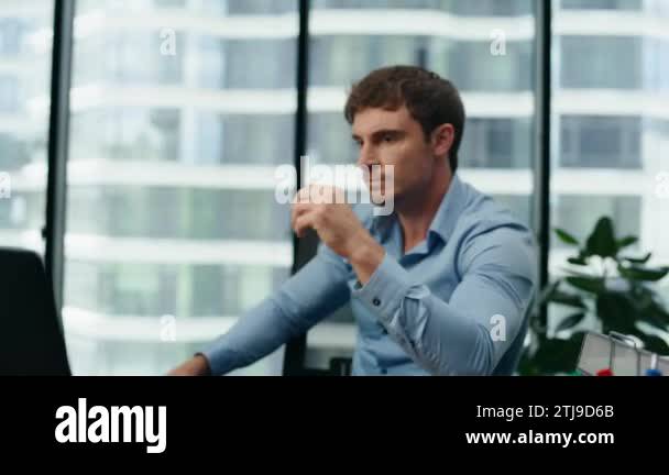 Desperate young man angry of failure work sitting modern office desk ...
