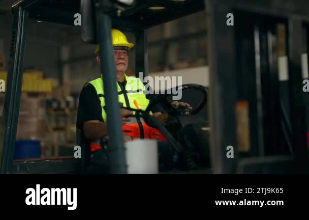 Warehouse worker working on forklift in factory, Senior forklift driver ...