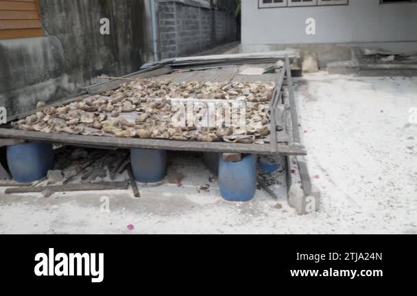 Traditional way to dry coconut shells and grated coconut in Bangkok ...