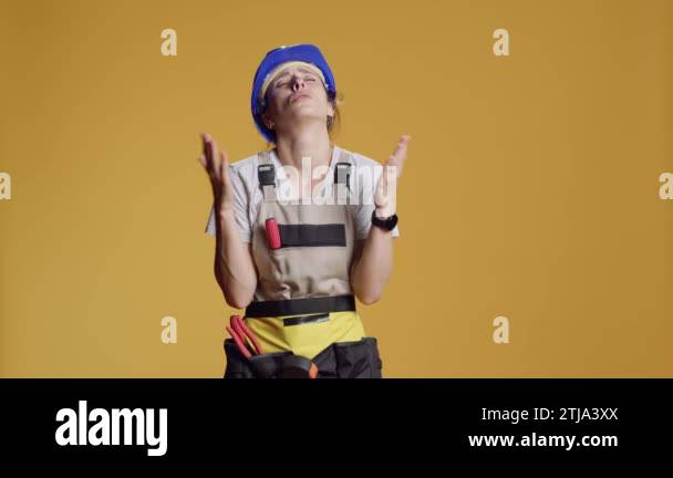 Portrait of construction worker doing prayer hands gesture, wishing to ...