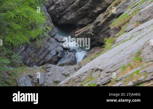 River between rocks of a narrow gorge. Stream of water is squeezed between the sides of the ...