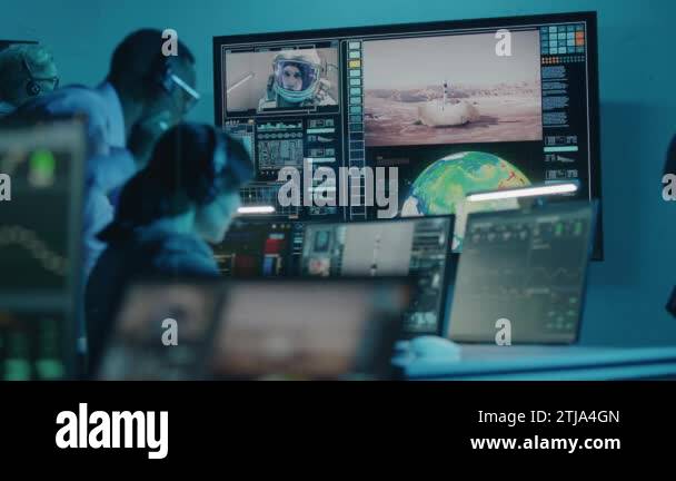 Flight control operators monitor space mission on computers in command ...