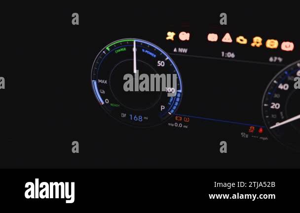 Electric car dashboard display closeup. Electric Car Concept. Battery indicator showing an ...