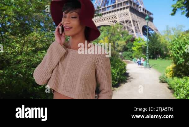 Good-looking young African-American woman makes a phone call while on ...