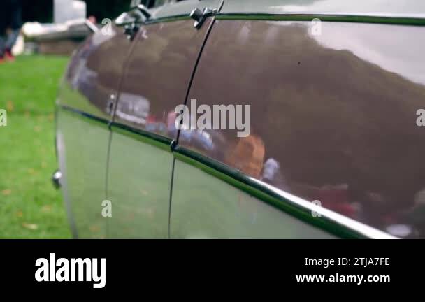 Vintage classic car side view in car park medium 4k tilting shot ...