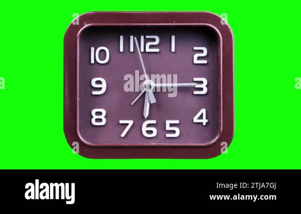 Timelapse of analog clock with spinning watch hands on a green ...