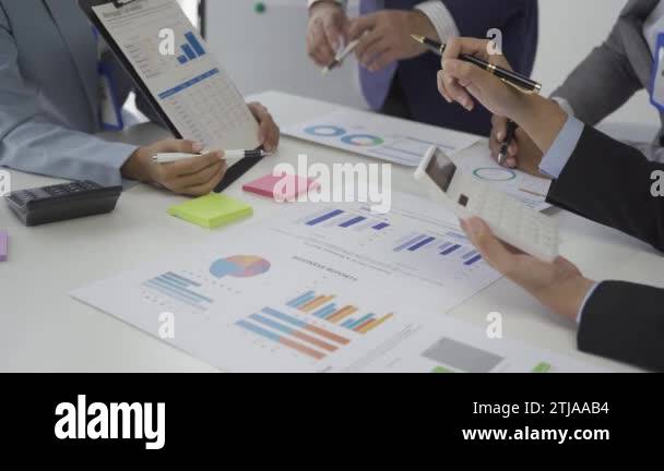 Accountant pointing to business graph chart Financial business report in chart Closeup ...