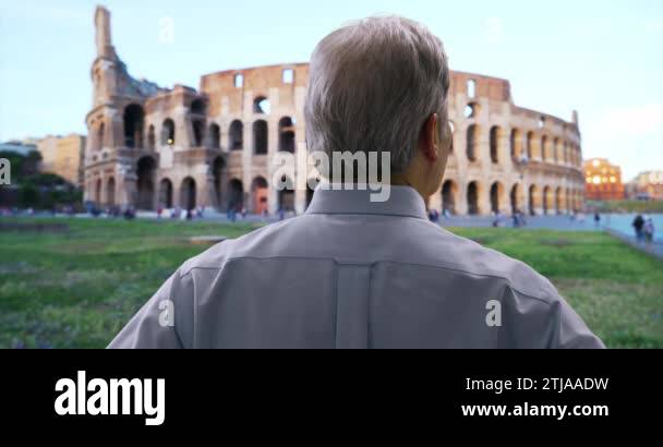 Older white man looks around in Rome near the Colosseum. Aged gentleman ...