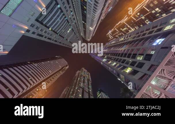 Look up to the night sky with tallest skyscrapers with illuminated ...