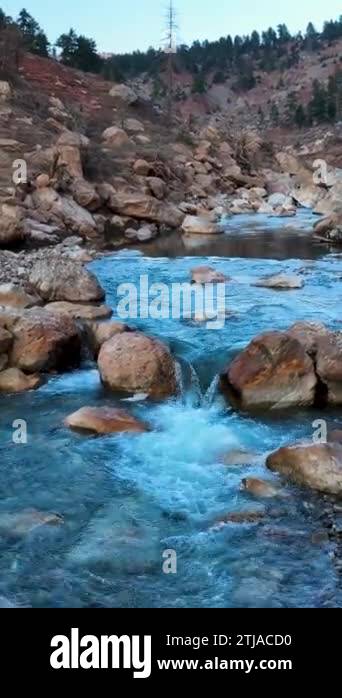 Capture the serenity of twilight as a fast-flowing river descends from ...