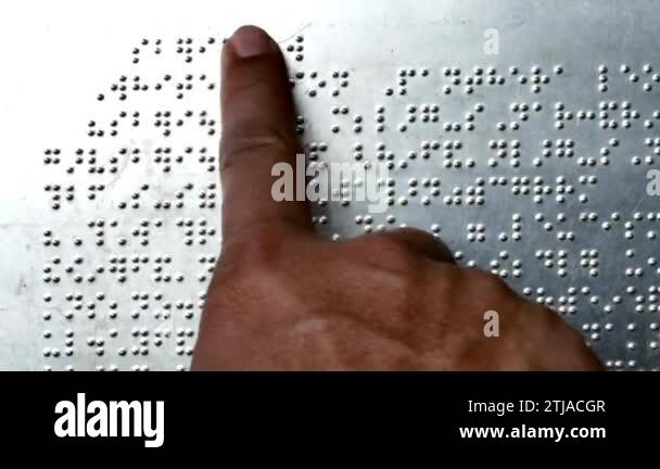 Close-up footage of the Braille writing system alphabet, the shot is ...