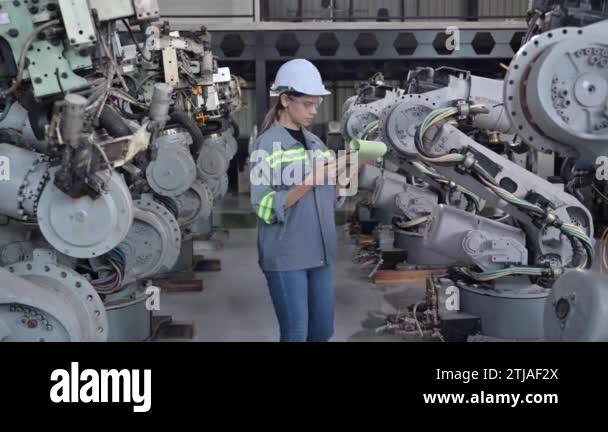 Maintenance engineer worker working with robotic machine automation at factory, Female ...