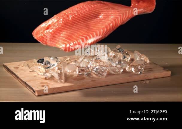 Salmon fillet falls on the table. Filmed is slow motion 1000 fps.. High ...