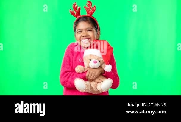 Green screen, Christmas and face of a child with a teddy isolated on a ...