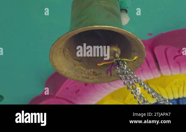Bell being rung in the temple. Hindu Temple Bell Closeup .The brass ...