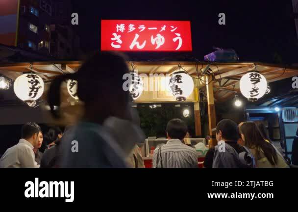 People having dinner at Yatai or street food stall in Hakata Tenjin ...