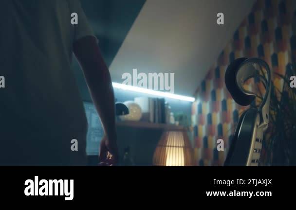 Guy in headphones sitting on chair at the table and starting to make 3D ...