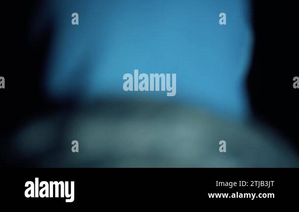 A man with a wooden stick in his hand encounters a white ghost in the ...