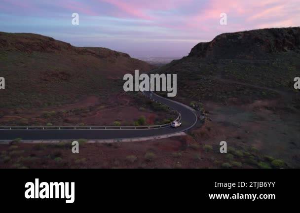 Car drives the road through beautiful canyons of rock formations during ...