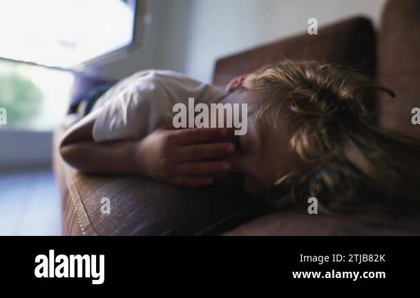 Sleepy child lying on couch napping. One little boy sleeping at home ...