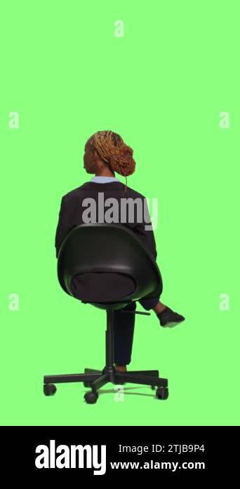 Vertical video: Office manager sitting on chair and waiting in studio ...