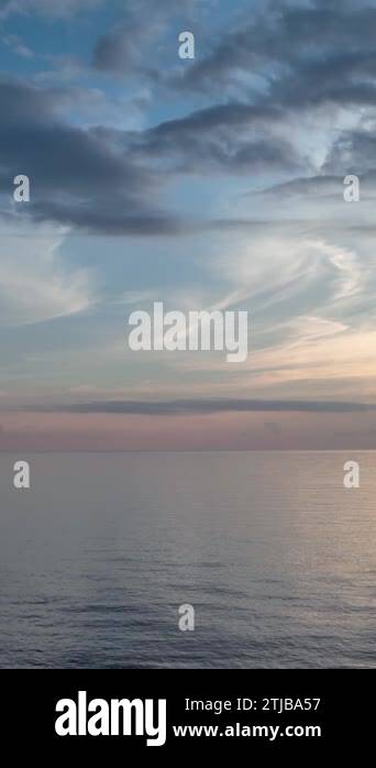 Witness the majestic sunset over the sea, where the sky unveils a vivid ...