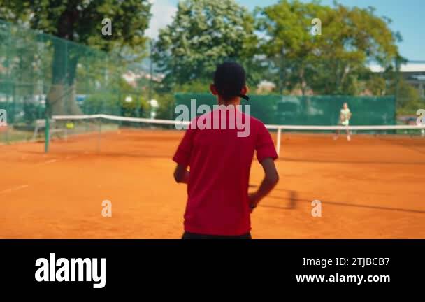Young tennis player hitting forehands strokes on hard court, swings for ...