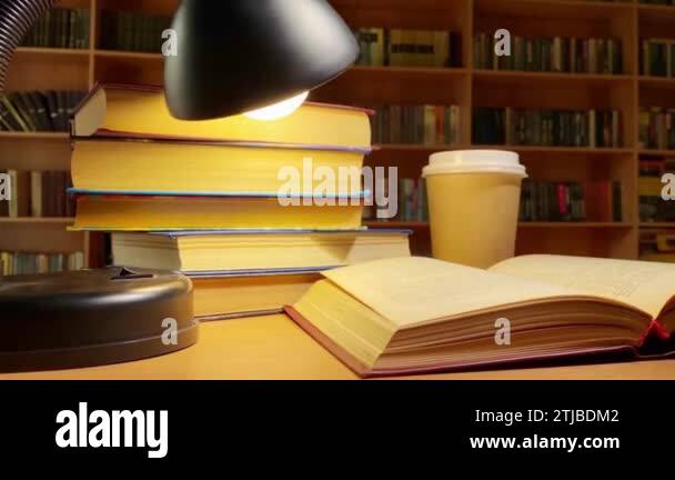 book in library with open textbook and blurry bookshelf on background ...