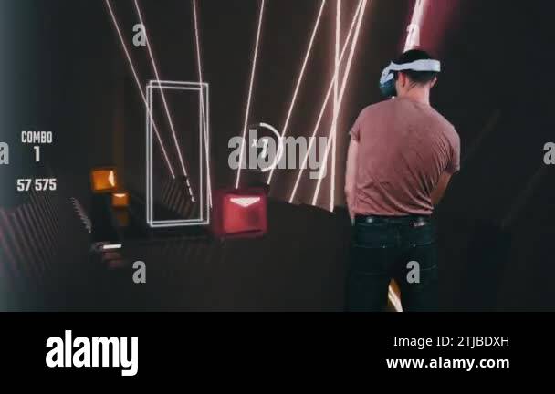 Person in virtual reality headset plays an action VR game in augmented ...