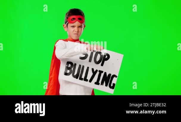 Superhero, stop bullying and boy with sign, green screen and costume ...