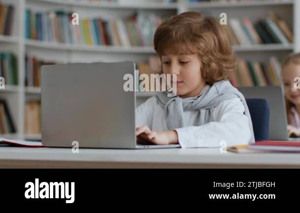 Interactive learning. Cute little preteen boy pupil embracing ...