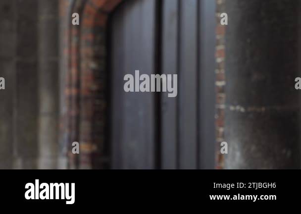 Out of focus background plate of brick wall and black wood door for ...