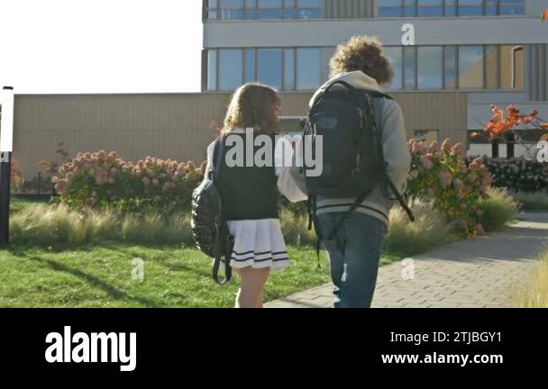 Two high school students, a boy and a girl, go to class. Teenagers are ...