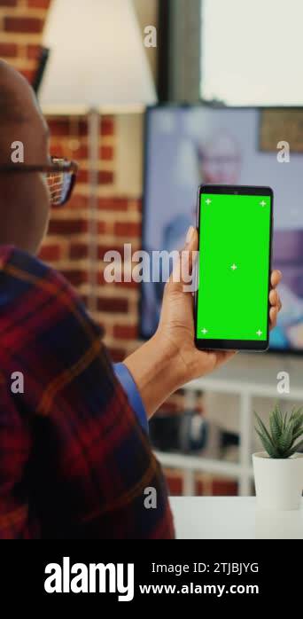 Vertical video: Young manager vertically holding mobile phone with ...