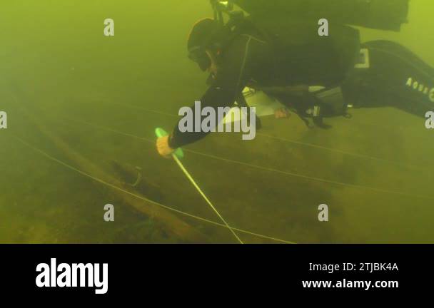 Underwater archaeological research: a scientist diver is making a ...