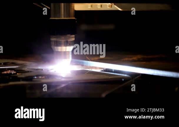 laser cut welding machine with light sparks effect on dark background ...