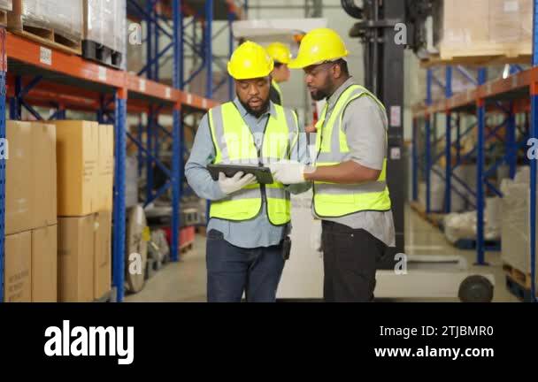 Warehouse workers checking and controlling boxes in warehouse ...