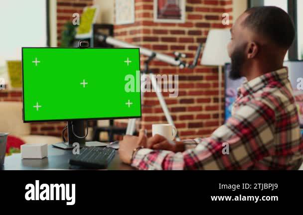 Smiling employee looking at chroma key mock up computer green screen ...